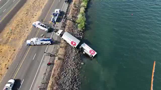 A sheen of fuel floats on the water during the I-84 truck removal ...